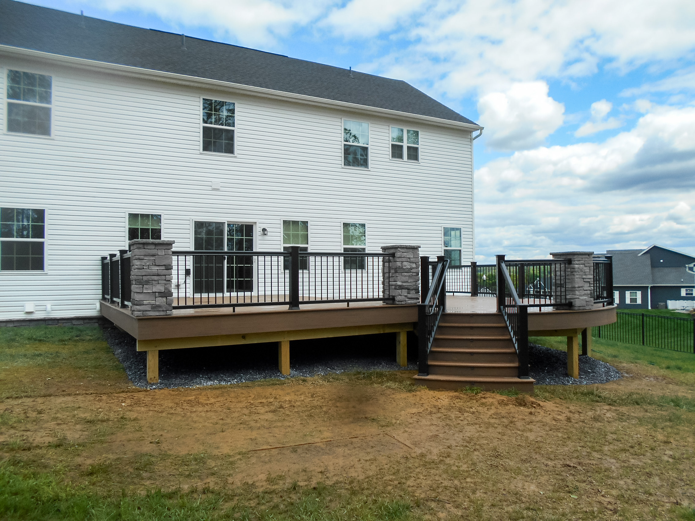 Curved Deck with Stone Pillars - Decks R Us